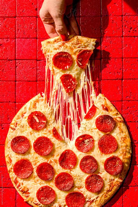Pepperoni Pizza Cheese Pull By Stocksy Contributor Gabriel Lucido