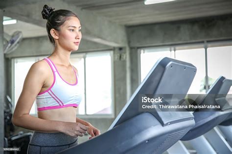 여자는 무게 제어 프로그램을 입력 하 고 젊은 사람들은 디딜 방 아에서 실행 젊은 여자는 체육관에서 훈련 아름 다운 운동 여자 체력 훈련입니다 갈색 머리에 대한 스톡 사진