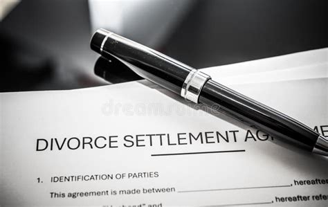 Divorce Settlement Agreement Document With Pen On Table Legal