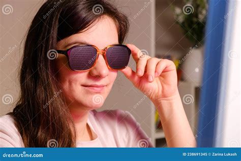 A Woman In Perforated Glasses Looks At The Computer Screen Stock Image
