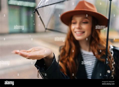 Selective Focus Of Cheerful Redhead Young Woman In Stylish Hat Raising Hand Up For Checking If