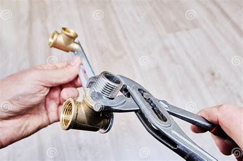 Wrench Is Tightening Stainless Steel Threaded Nipple Wrapped In