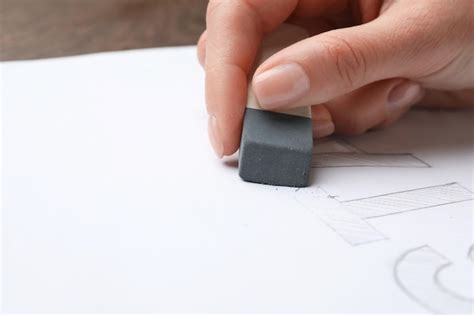 Premium Photo Woman Erasing Word On Sheet Of White Paper At Table Closeup
