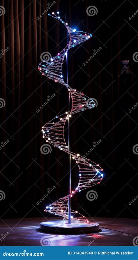 Illuminated Dna Double Helix Sculpture With Colorful Lights Against A Dark Background Stock
