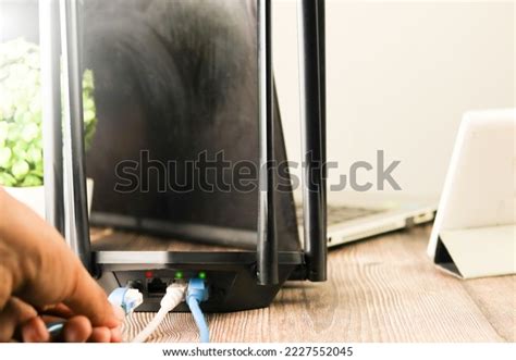 Man Plugs Internet Cable Into Router Stock Photo Shutterstock