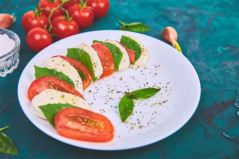 슬라이스 토마토 모짜렐라 치즈 바질 올리브 오일 옴 녹색 배경 이탈리아 어 카프리즈 샐러드 텍스트에 대한 공간이 있는 맨 위 보기 0명에 대한 스톡 사진 및 기타 이미지