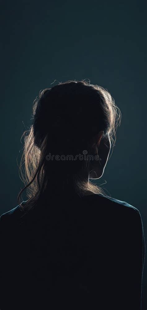 Moody Silhouette Of A Girl From The Back Against A Dark Background