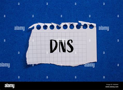 Dns Word Written On Ripped White Paper With Blue Background Conceptual Dns Symbol Copy Space