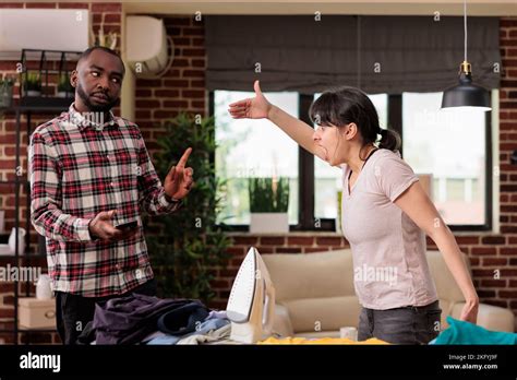 Multiracial Couple Having A Big Argument At Home Shouting And Arguing Over Unresolved Issues In