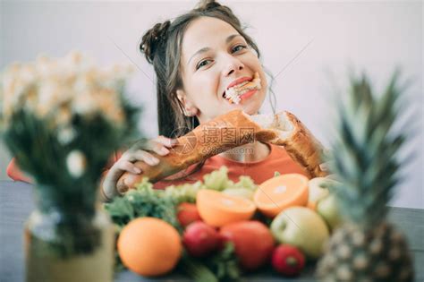 节食的年轻女子屈服于诱惑高清图片下载 正版图片504365238 摄图网
