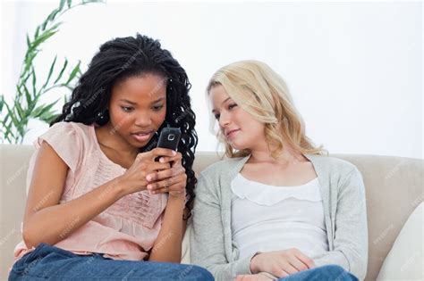 Premium Photo A Woman Is Texting On Her Mobile Phone While Her Friend