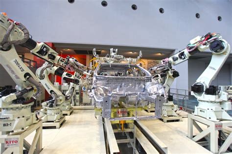 A Car Being Assembled By Robots At The Toyota Commemorative Museum Of Industry And Technology In