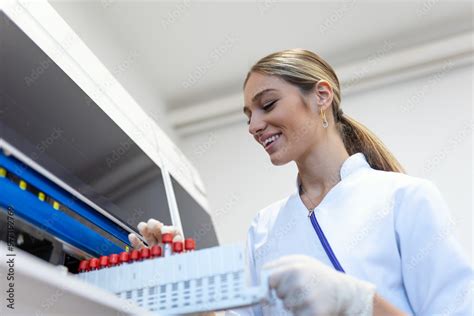 Portrait Of A Babe Female Laboratory Assistant Making Analysis With Test Tubes And Analyzer