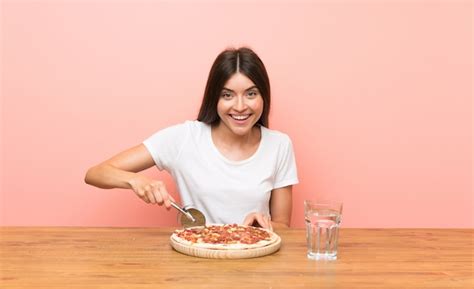Premium Photo Young Woman With A Pizza In A Table