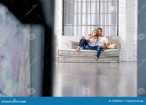 Young Couple Cuddling On The Sofa Stock Image Image Of Passion Home 143593651