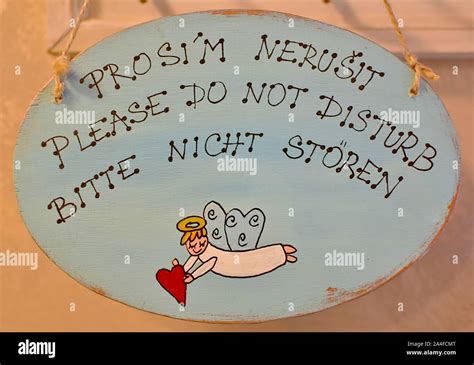 A Sign On The Hotel Door Please Do Not Disturb In Tree Languages Stock