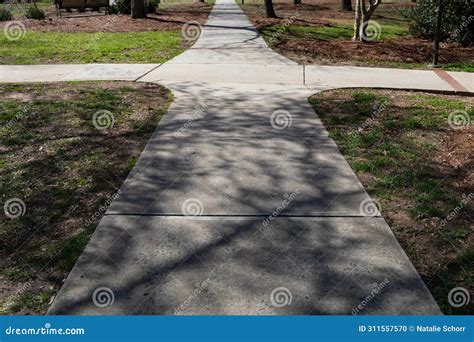 Intersecting Sidewalks With One In Deep Shadows And One In Bright Light