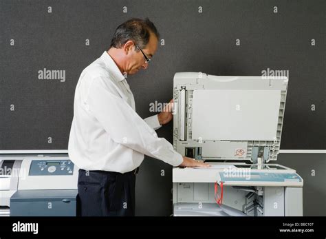 Man Making Photocopy In Office Stock Photo Alamy