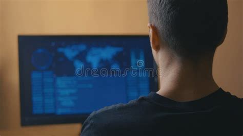 Back View Of Man Programmer Hacker Working And Drinking Coffee At