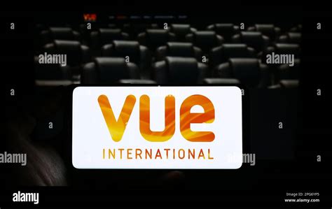 person holding mobile phone with logo of entertainment company vue