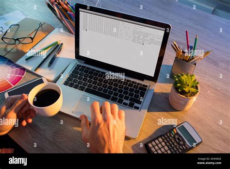 Hands Of Caucasian Male Programmer Sitting At Desk And Using Laptop With Coding On Screen