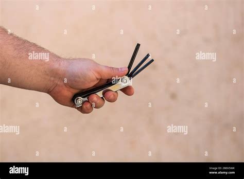 Tools For Repair And Building Hand Holding Set Of Special Keys Imbus Keys On Blurred