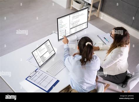 programmer woman wearing hijab working coding business software stock