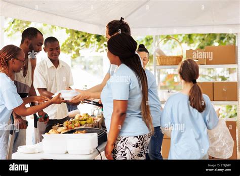 African American Woman And Multiethnic Volunteers Helping And Giving