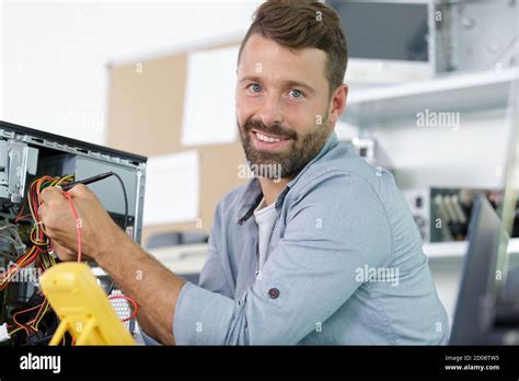 A Happy Man Fixing A Computer Stock Photo Alamy
