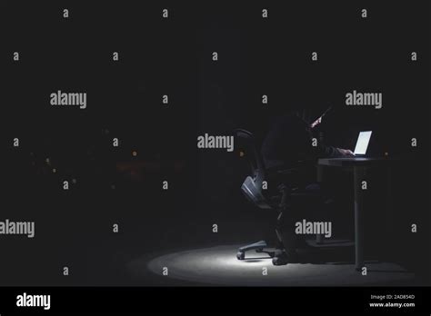 Hacker Using Laptop Computer While Working In Dark Office Stock Photo Alamy