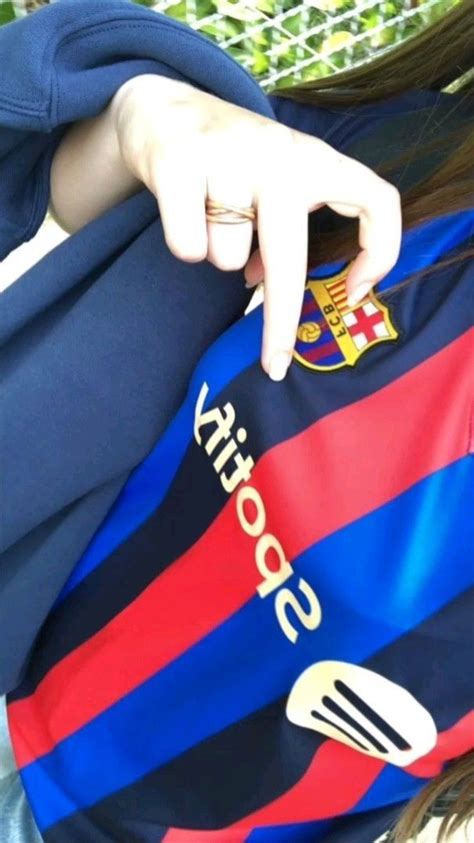 A Person Wearing A Blue And Red Striped Shirt Pointing At Something With Their Finger In The Pocket