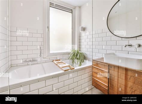 Sinks With Mirrors And Clean Bathtub Washing Machine Located Near