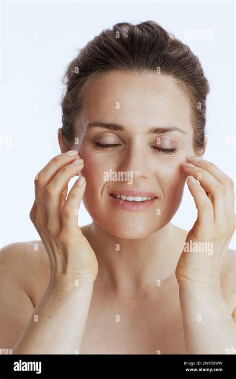 Happy Modern Woman Doing Facial Massage Against White Background Stock