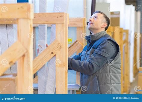 Man Stacking Materials In Wooden Racking Stock Photo Image Of Store Business 258545866