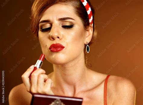 Girl In Pin Up Retro Style Do Makeup Make Up With Red Lipstick Sexy Girl Look Down And Paints