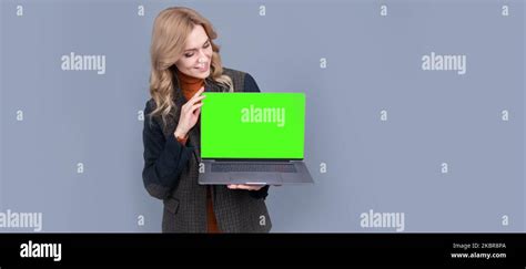 Business Woman Look At Laptop With Blank Neon Green Screen For Copy
