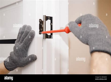Carpenter Worker Installation Process Of Wood Door Hinge Stock Photo Alamy