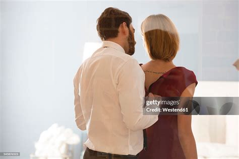 Man Unzipping Womans Dress In Bedroom Photo Getty Images