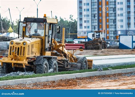 Road Grader At The Construction Site Powerful Construction Machine For