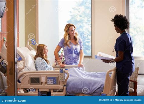 Nurse Talks To Mother With Teenage Daughter In Hospital Stock Image