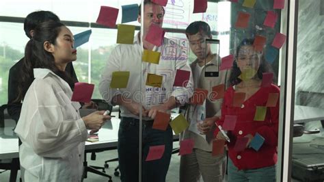 Business Team Brainstorming Marketing Idea By Using Sticky Notes
