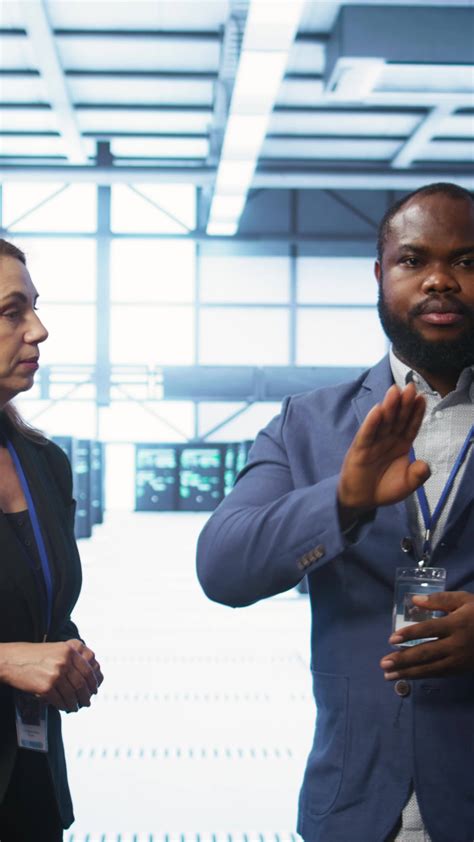 Vertical Team Of Admins In High Tech Data Center Looking At Hologram Visualization Engineer And