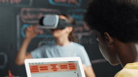 African Boy Programming System While Caucasian Girl Enter Metaverse