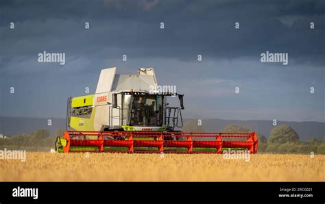 Harvesting Winter Barley With A Claas Lexicon 7500 Combine Harvester On A Stormy Summers Evening