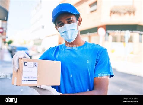 African Delivery Man Wearing Courier Uniform Outdoors Wearing