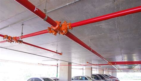 Red Fire Protective Water Pipeline System On Concrete Ceiling Inside Of