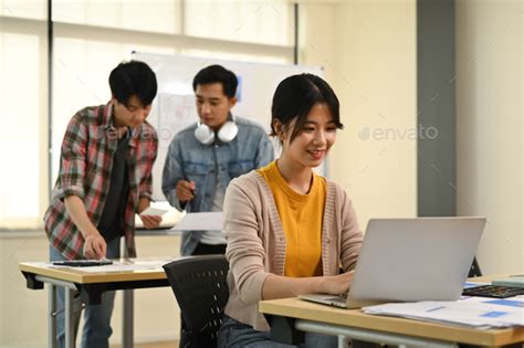 Developer Team Collaborating And Planning Template Layout For Mobile Application In Office