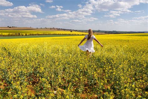 Country Girl Frollicking In Fields Of Golden Canola Stock Image Colourbox