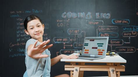 Asian Student Programing Engineering Code With Equipment On Table