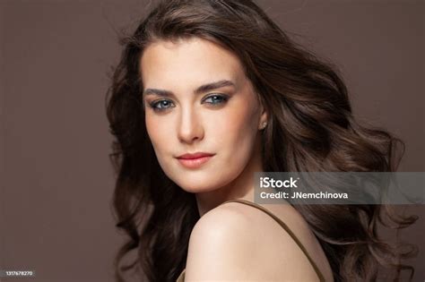 갈색 배경에 맑은 피부와 건강한 물결 모양의 머리와 예쁜 미소 여자 갈색 머리의 초상화 자연 메이크업을 가진 아름다운 여자 18 19세에 대한 스톡 사진 및 기타 이미지